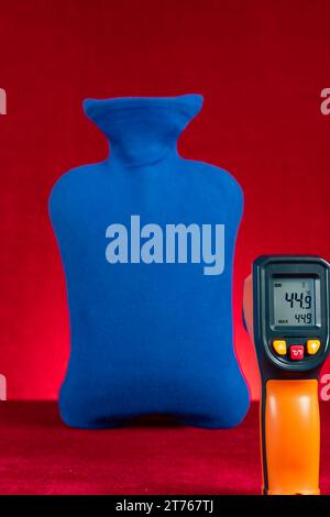 infrared thermometer shows the surface temperature of a hot water ...