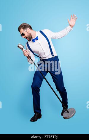 Full size fullbody portrait of famous creative singer in blue pants ...