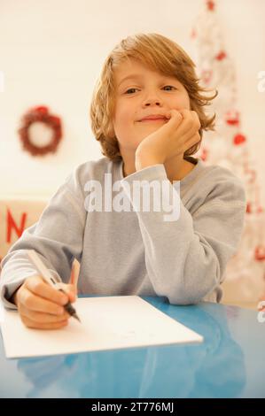 Boy writing a letter to Father Christmas Stock Photo - Alamy
