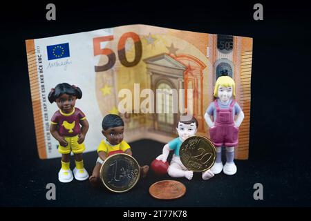 children's plastic figures with euro coins, symbolic image of child ...