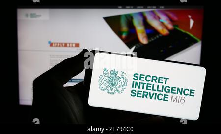 Person holding cellphone with seal of British agency Secret ...