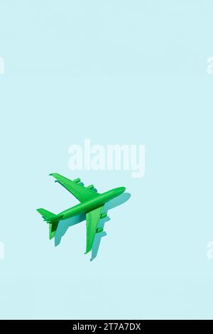 Sustainable aviation concept - green plane. Background with copy space ...