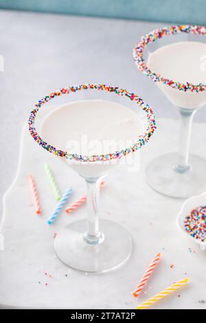 Birthday cake martini with sprinkles on the glass rim topped with ...