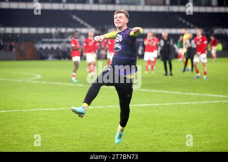 Crewe Alexandra goalkeeper Tom Booth celebrates victory in front of the ...