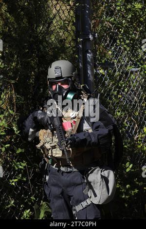 A soldier wearing a nuclear-biological-chemical (NBC) protective suit ...