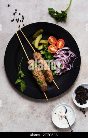 Delicious arabic fast food skewers black plate Stock Photo - Alamy