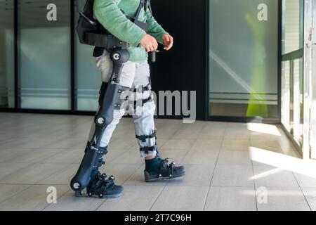 Mechanical exoskeleton, disabled person walking with the help of ...