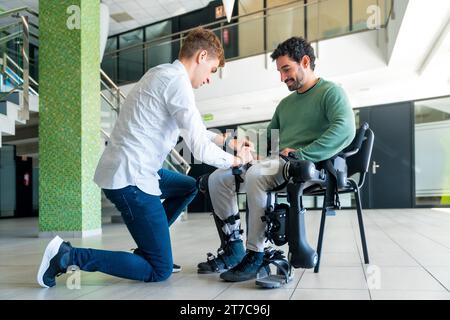 Mechanical exoskeleton, physiotherapist placing the tapes on the chest ...