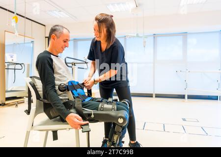 Mechanical exoskeleton, disabled person on his back walking with the ...