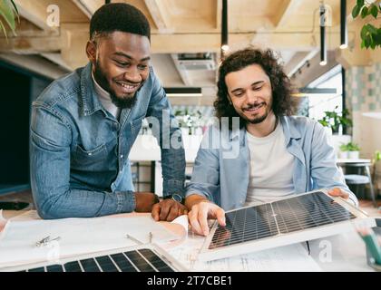 Medium shot smiley men with project Stock Photo - Alamy