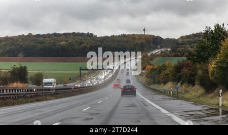 29 October 2023, Hesse, Ober-Mörlen: Cars driving at dusk in the rain ...