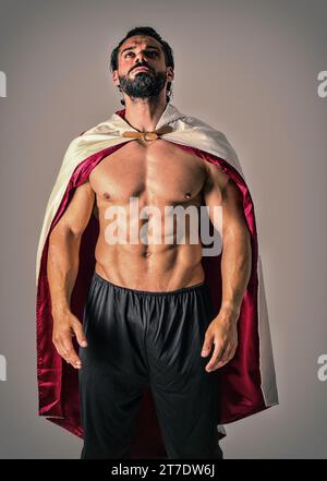 Man wearing superhero cape and mask on white background Stock Photo - Alamy