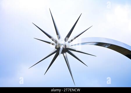 metallic silver coloured spiked sculpture with blue sky background ...