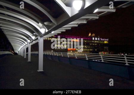 illuminated bells bridge in glasgow at night with bbc centre in the ...