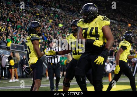 Oregon wide receiver Tez Johnson (15) amd quarterback Dillon Gabriel (8 ...