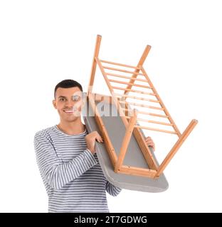 Young man carrying soft bench on white background Stock Photo - Alamy