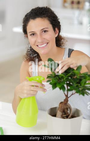 a woman watering bonsai tree Stock Photo - Alamy