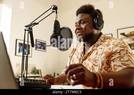 Male radio presenter with microphone recording in studio Stock Photo ...