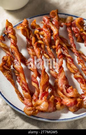 Homemade Trendy Twisted Bacon Strips on a Plate Stock Photo - Alamy