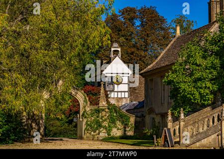 The tudor-style architecture of the courtyard and clock tower at Lacock ...