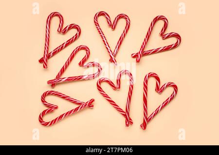 Pattern with hearts made of Christmas candy canes on yellow background ...
