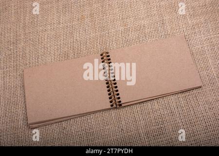 brown color notebook placed on a canvas background Stock Photo - Alamy