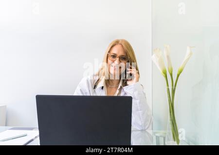 Female patient talking on telephone in hospital bed Stock Photo - Alamy