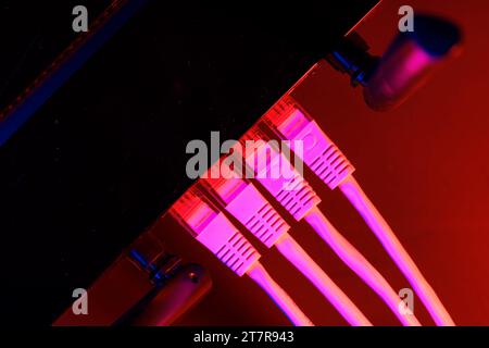 Cables plugged in a Wi-Fi router on dark background Stock Photo - Alamy