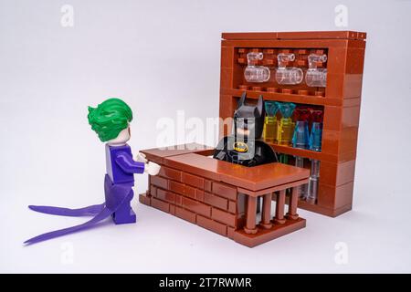 A Bar scene with lego mini figures of Batman and Joker on a white ...