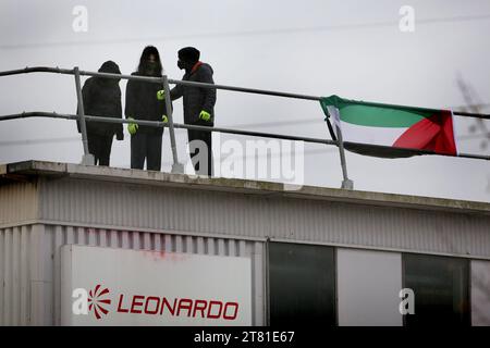 Activists talk on the roof beside a Palestinian flag and the Leonardo ...