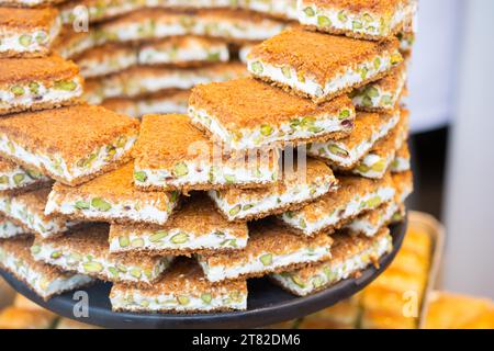 Turkish traditional dessert Kadayif baked in syrup served with nut ...