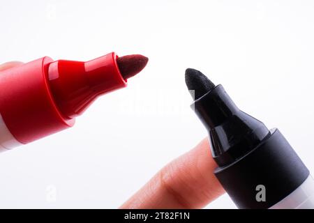 Hand holding Color markers face to face on a white background Stock ...