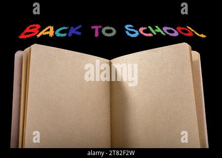 Brown color notebook open on a black background Stock Photo - Alamy