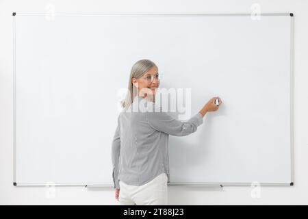 Portrait of professor explaining something at whiteboard indoors Stock ...
