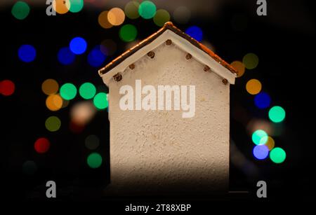Small decorative model houses in christmas lights Stock Photo - Alamy