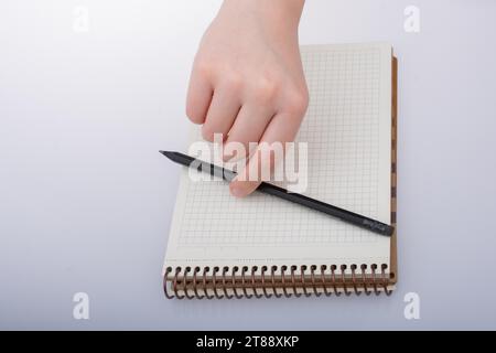 Human hand using pen to write down short note on notebook Stock Photo ...