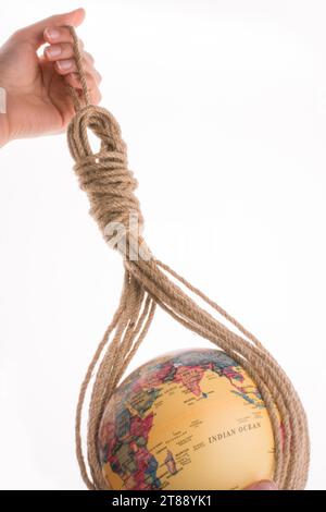 globe hanging in rope on white background Stock Photo - Alamy