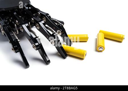Real robotic hand and rechargeable AA battery cells on white background ...