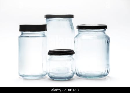 Set with closed empty glass jars on white background Stock Photo - Alamy