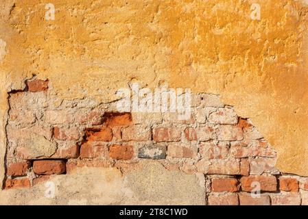 Brick and plaster yellow ochre background Stock Photo - Alamy