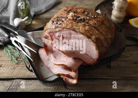 Delicious baked ham, carving fork, orange slice, pomegranate seeds and ...