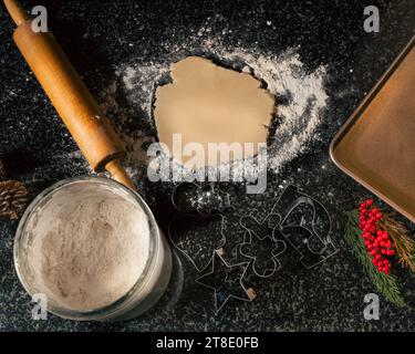 Flat lay. Rolling out sugar cookie dough to bake Christmas cookies ...