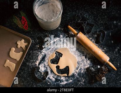 Flat lay. Rolling out sugar cookie dough to bake Christmas cookies ...