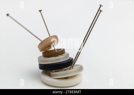 Horizontal photo, buttons stacked with pins, on white background, copy ...