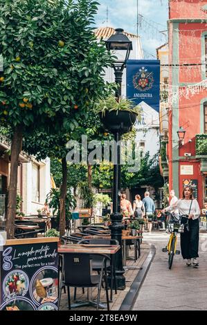 Cafe tables on Streets of Marbella, Spain Stock Photo - Alamy