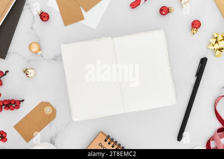 Christmas composition of open blank notepad, coffee cup, Christmas tree ...