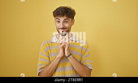 Arab man standing over yellow background covering eyes with hands ...