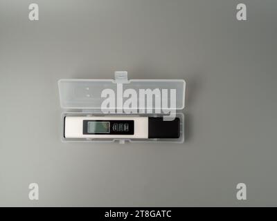 Water quality tester on a gray background. Device for measuring water ...