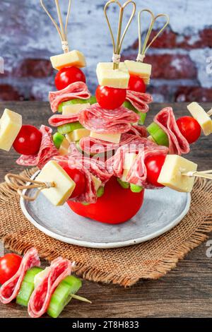 Mini Greek deli kebabs with salami, cheese, cherry tomatos and cucumber ...