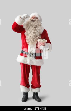 Santa Claus with tasty popcorn on white background Stock Photo - Alamy